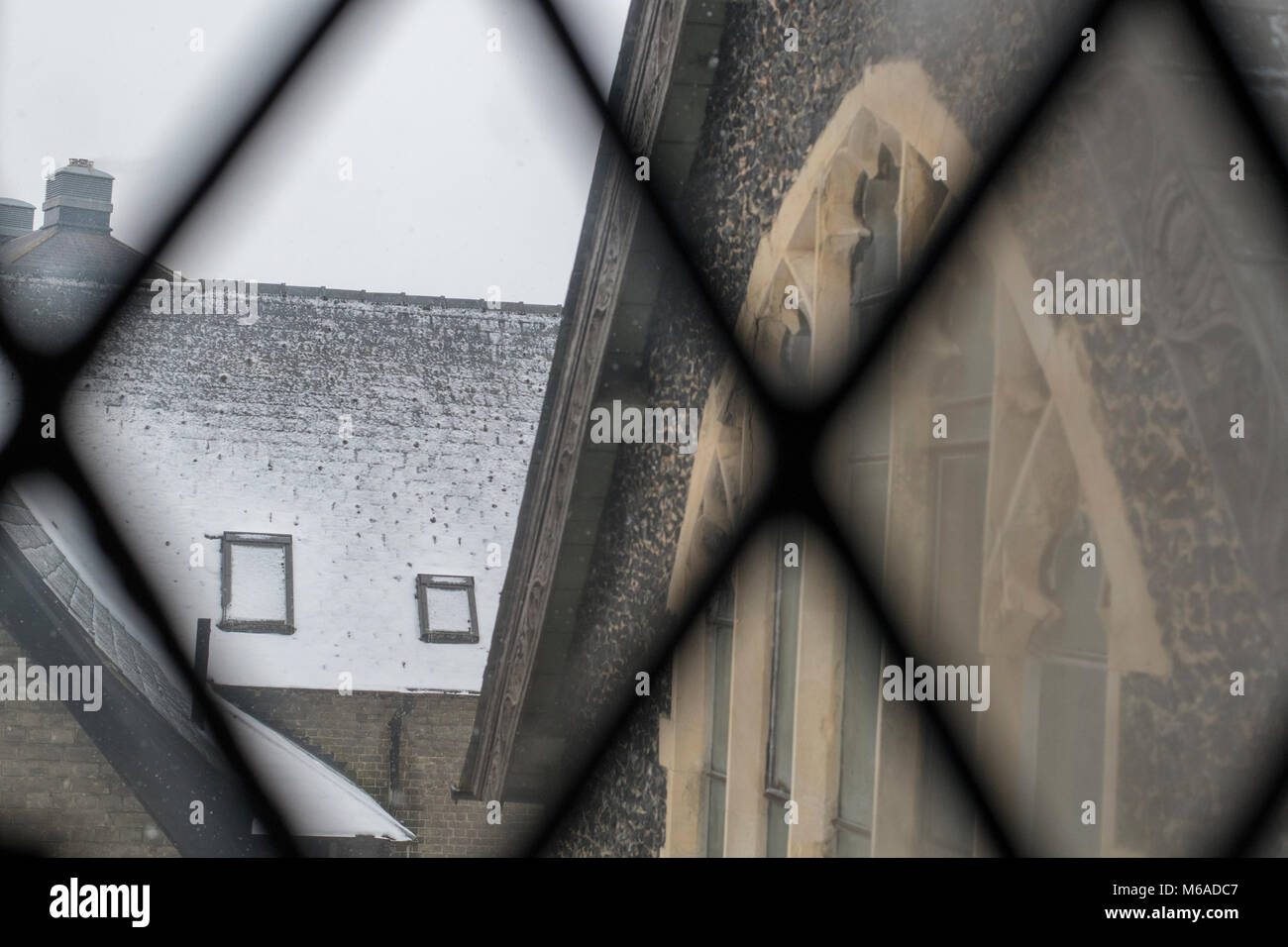 Snow on rooftops through leaded glass window Stock Photo - Alamy