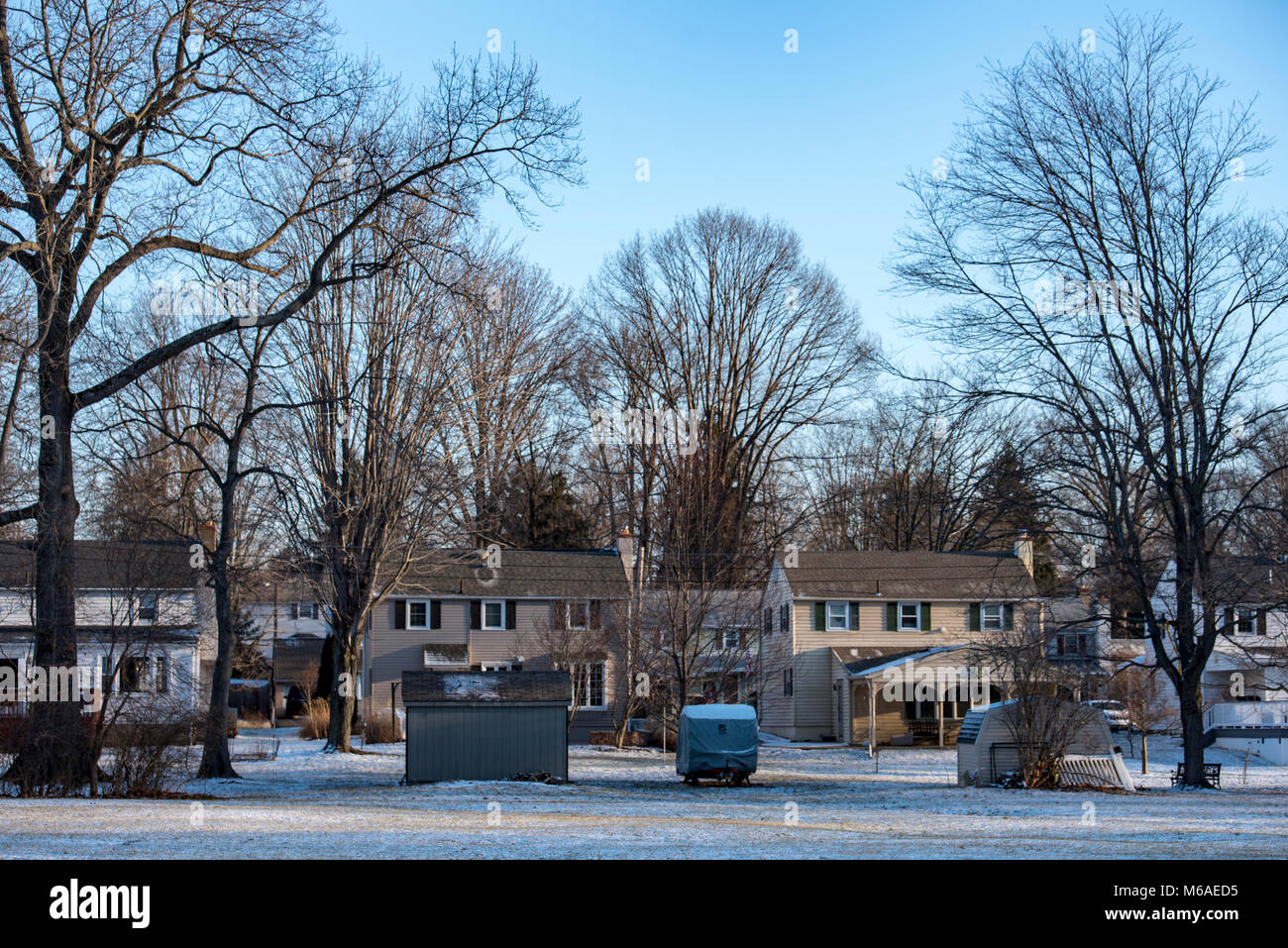 Photograph of Suburban home exteriours with sky and treeline visible ...