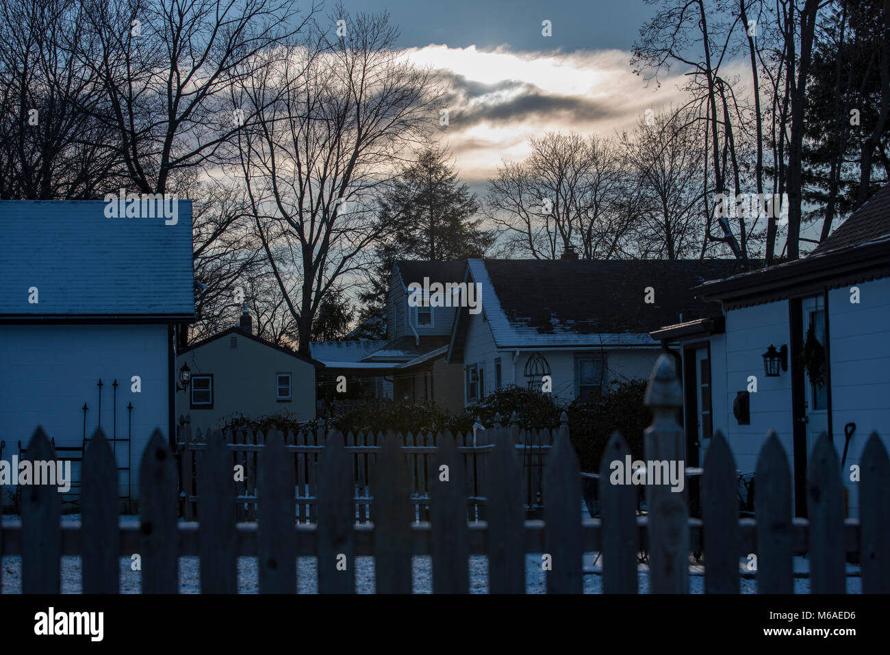 Photograph of Suburban home exteriours with sky and treeline visible ...