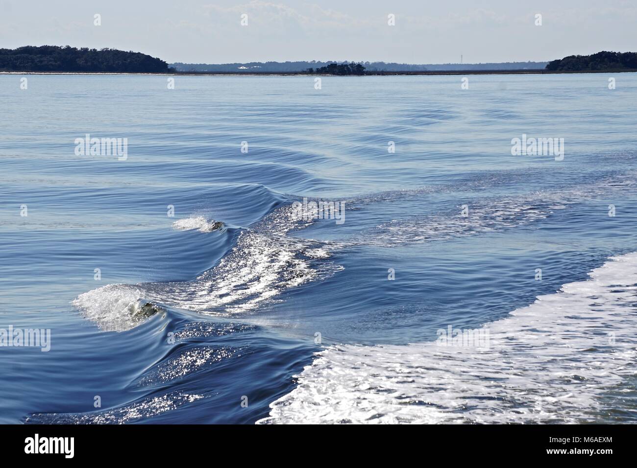 Patterns of waves in water, in the wake behind a boat Stock Photo - Alamy