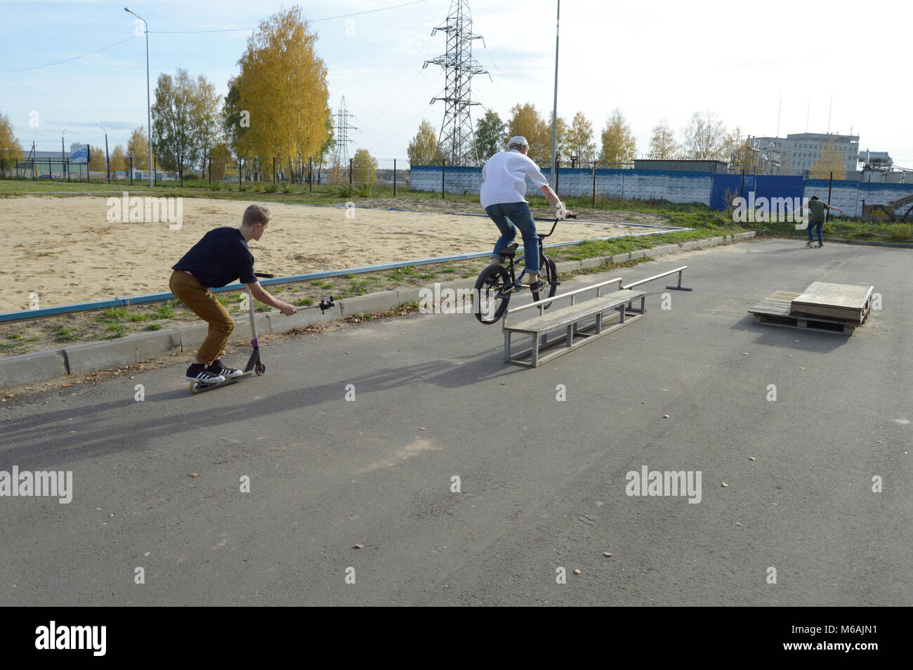 Kovrov, Russia. 2 October 2016. Teenager on a scooter with action camera shoots teen on BMX bike ...