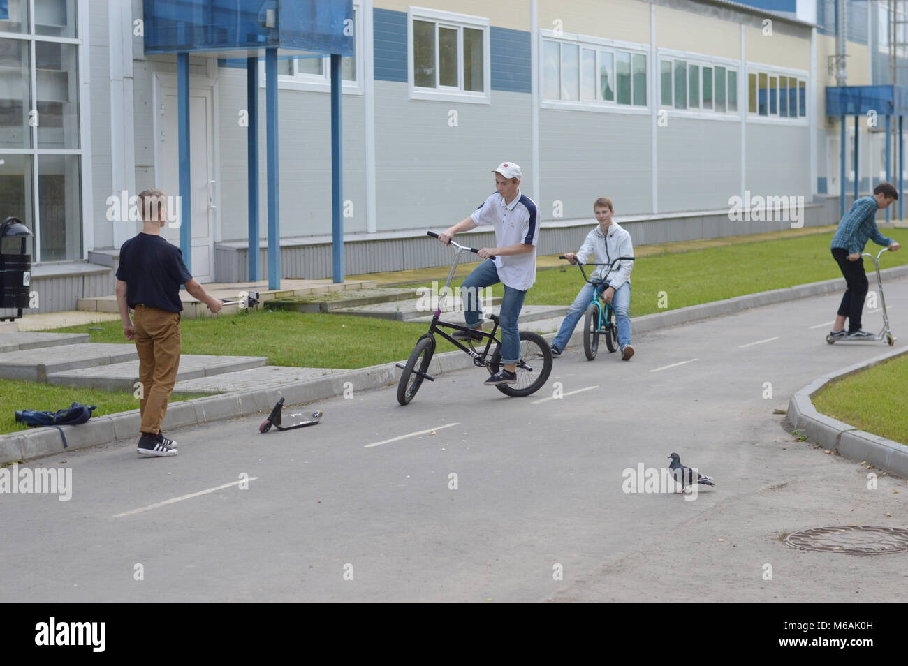 Kovrov, Russia. 2 October 2016. Teen on a BMX bike with a rudder from a scooter in the ...
