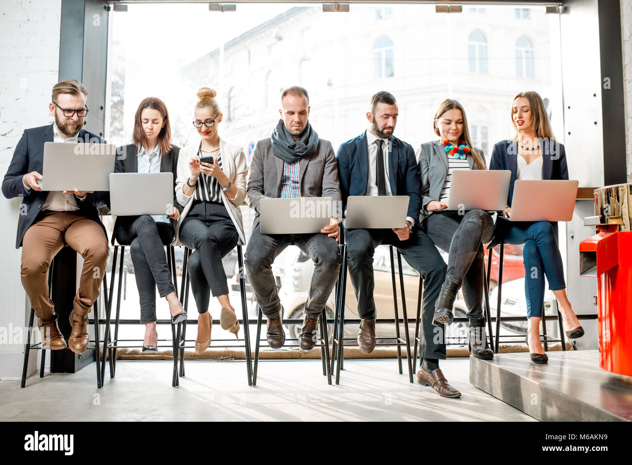 Business people working near the window Stock Photo - Alamy
