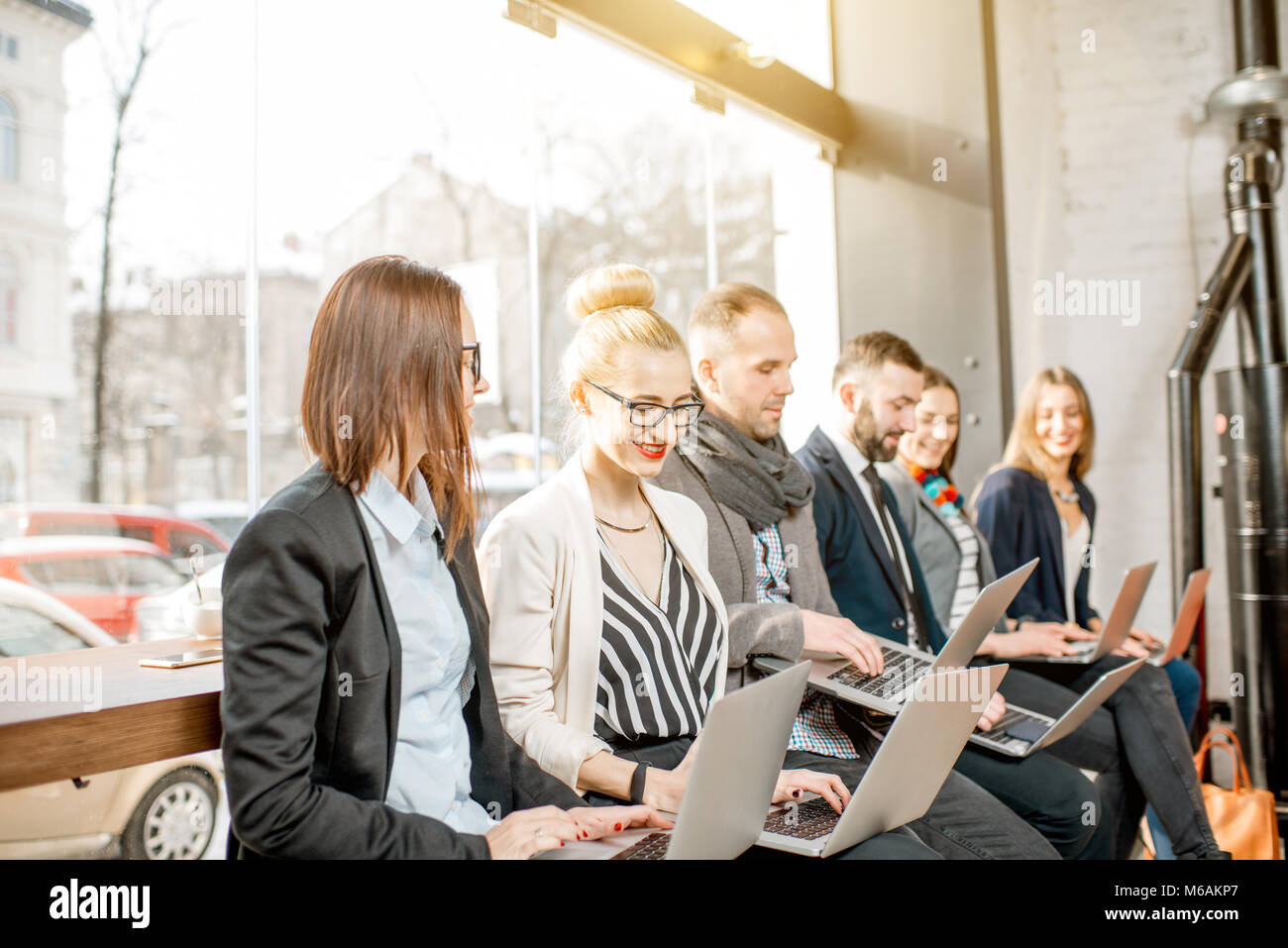 Business people working near the window Stock Photo - Alamy