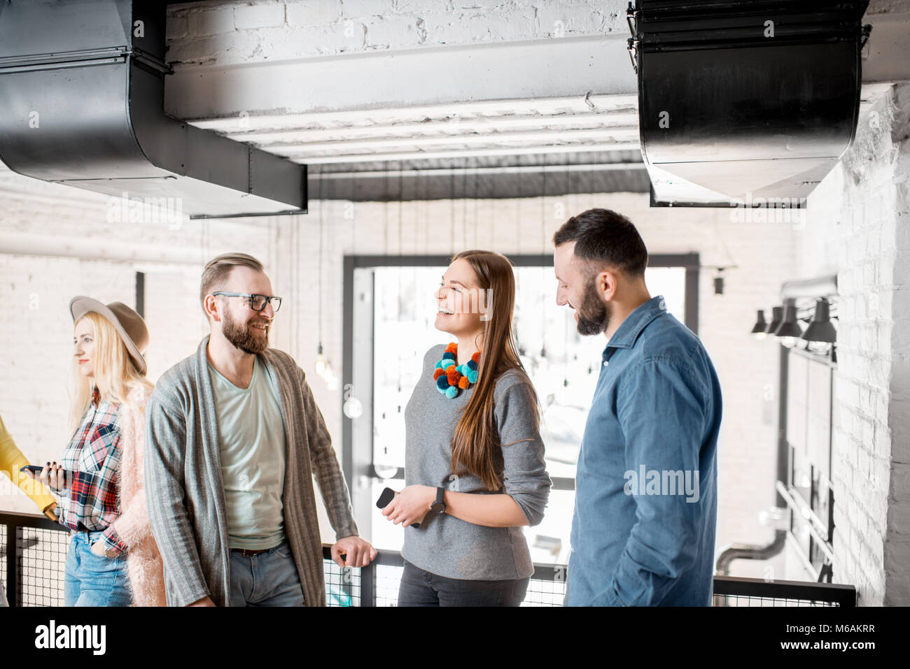 Friends talking during the break in the conference hall Stock Photo - Alamy