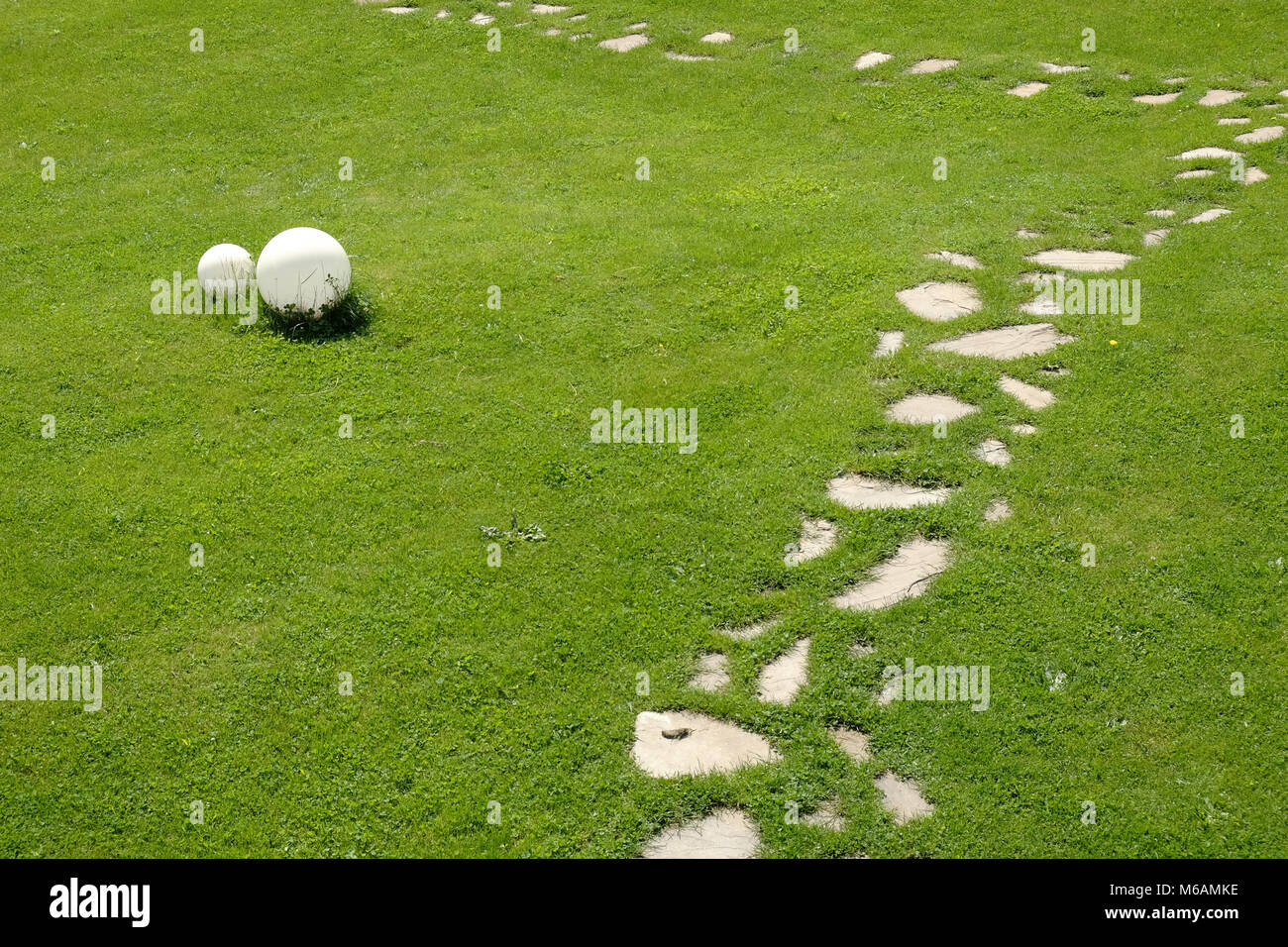 Fresh green grass with rock pathway Stock Photo - Alamy