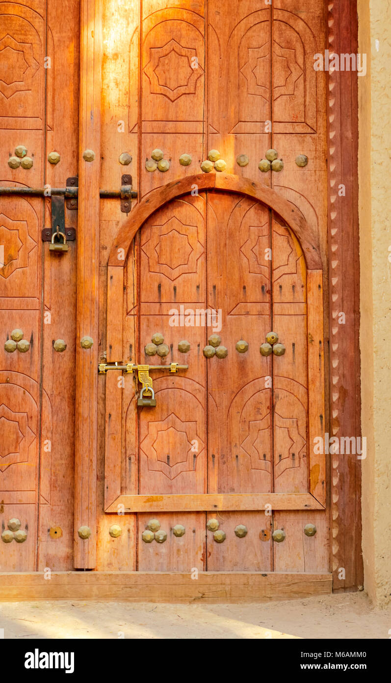 A traditional Arabian 'door within a door' in a building in in Al Ain ...