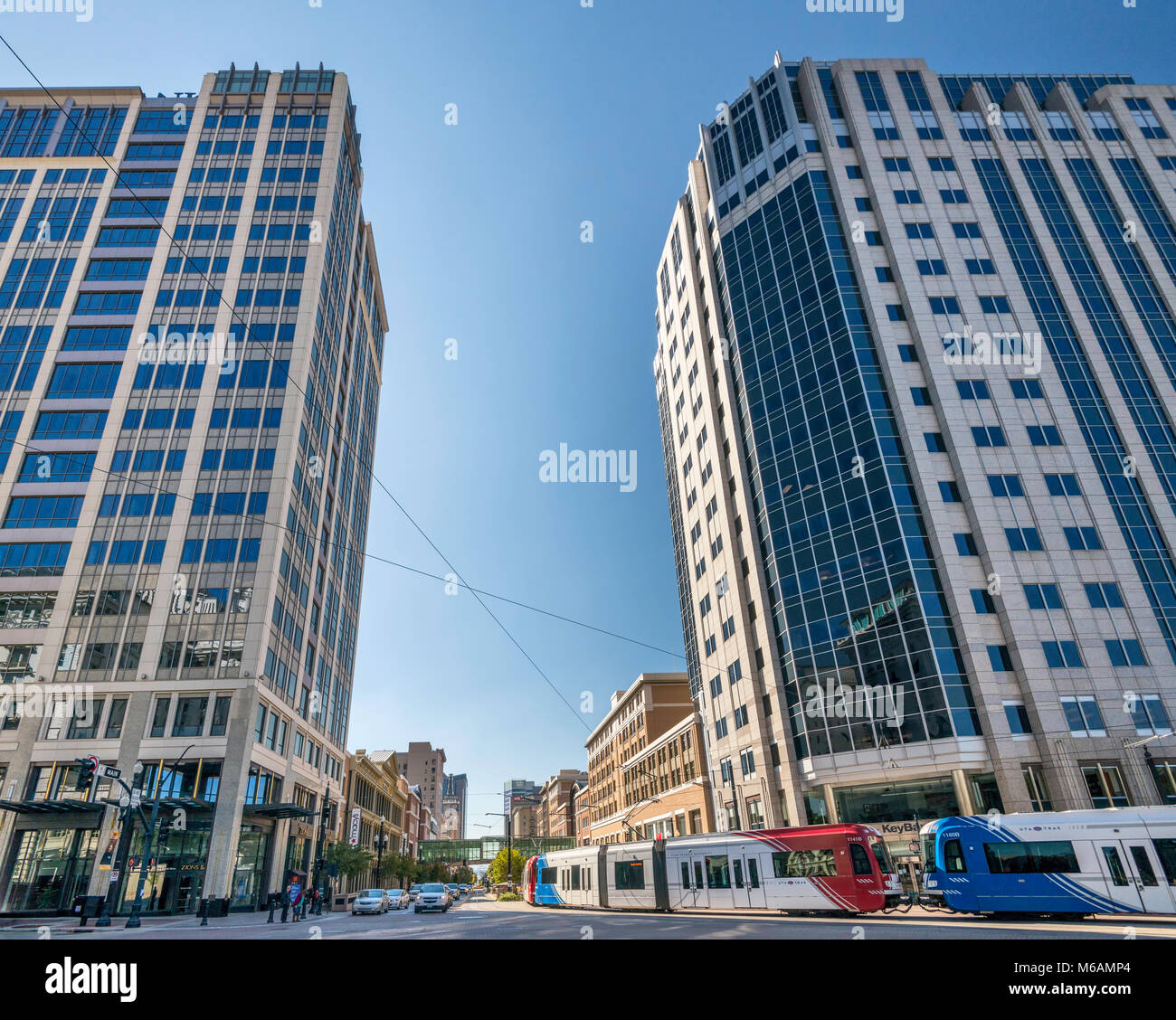 Office towers, TRAX light rail train on South Temple Street turning ...