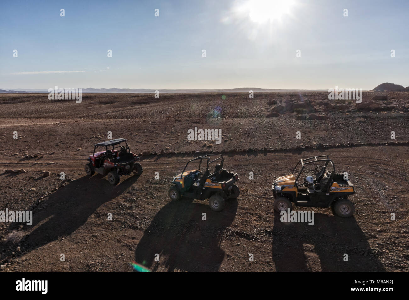 three-wheeled all-terrain buggy, overlooking the arid landscape of ...