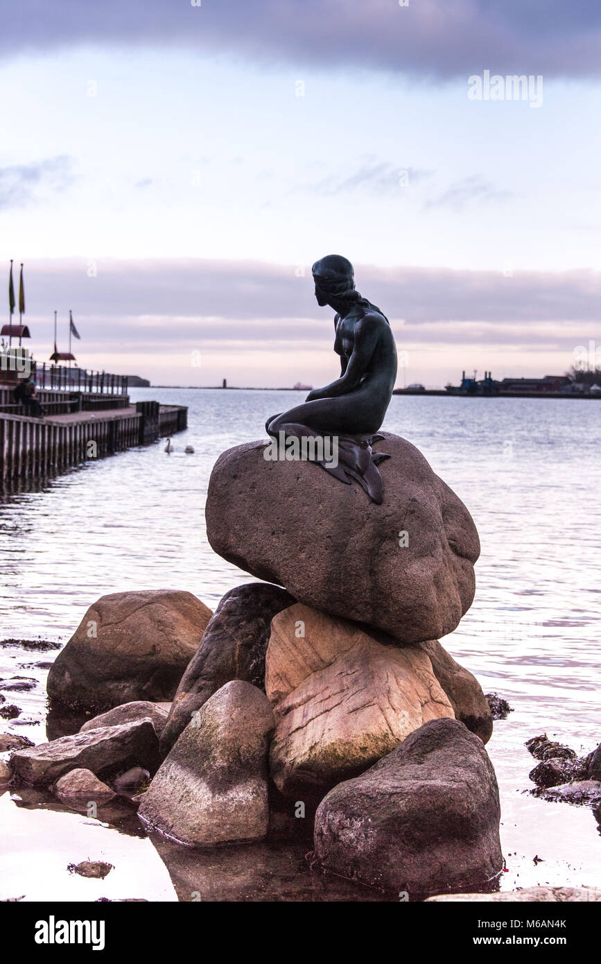 Mermaid statue on the stones by the sea at sunset Stock Photo - Alamy