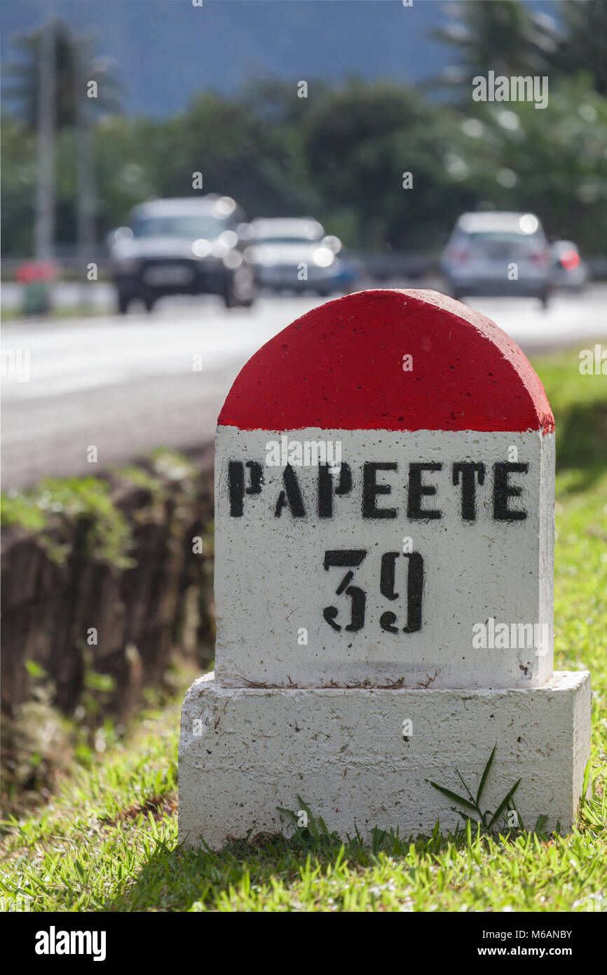 Kilometre stone, Papeete 39, roadside, cars, Tahiti, French Polynesia ...