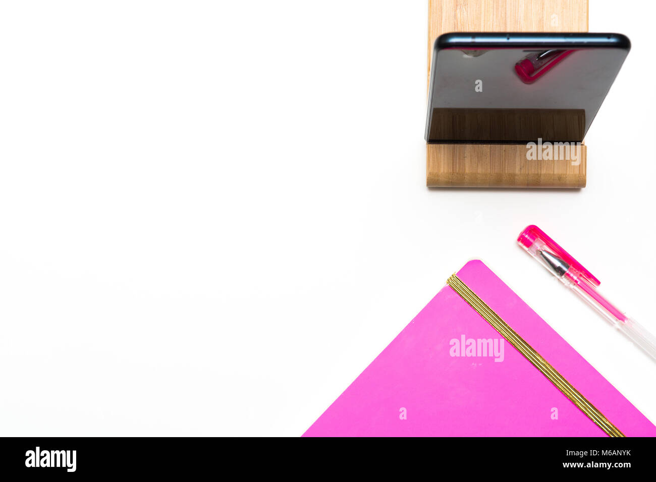 mobile phone and note pad on a white office table Stock Photo - Alamy