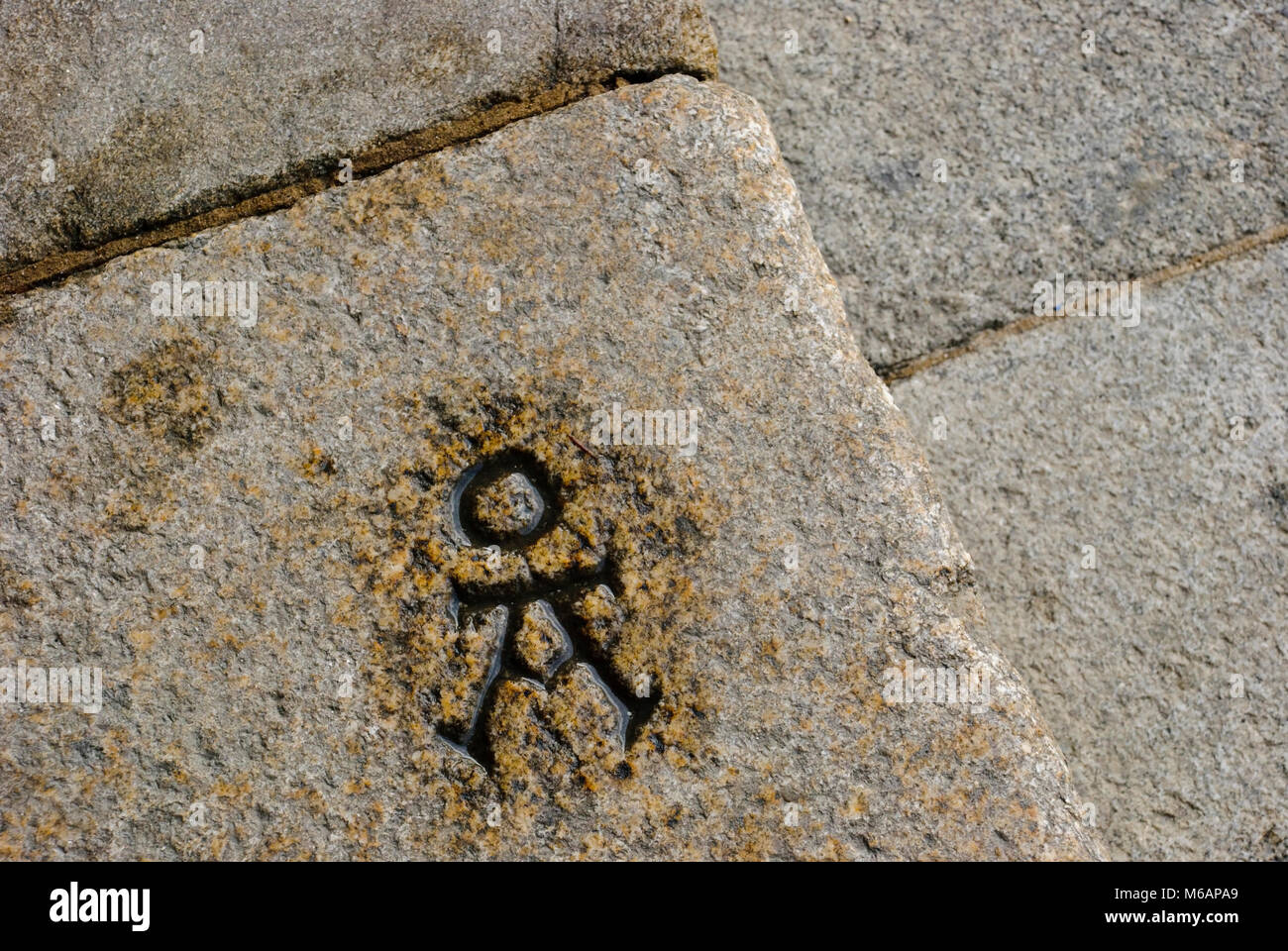 Ancient human symbol, chiseled in stone Stock Photo - Alamy