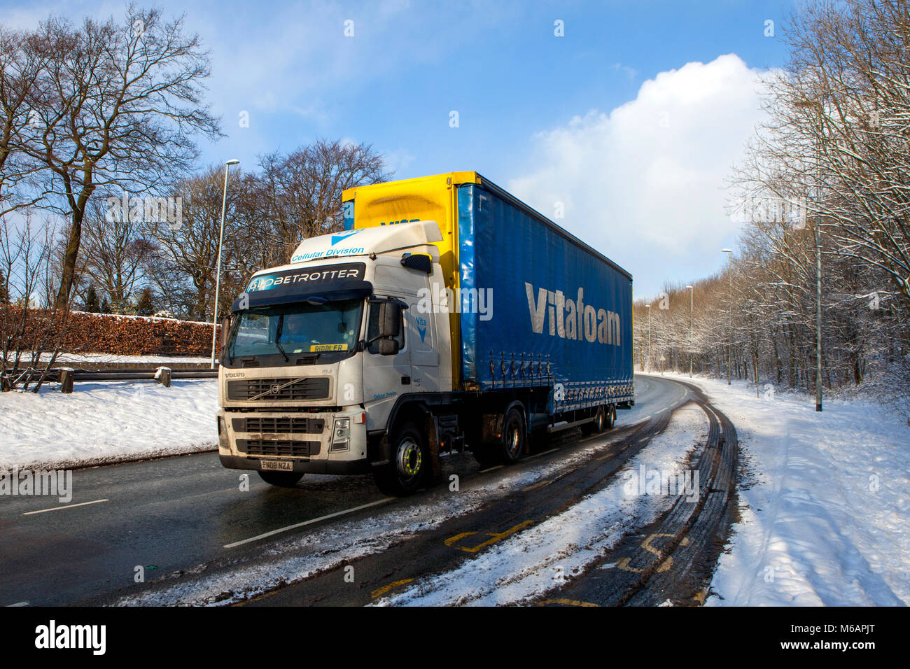 Vitafoam HGV lorry driving in winter with snow on pavement Stock Photo ...