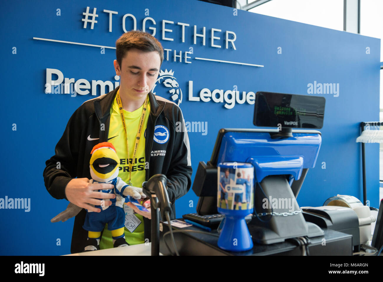 a male member of staff at the club shop at the Brighton and Hove Albion ...