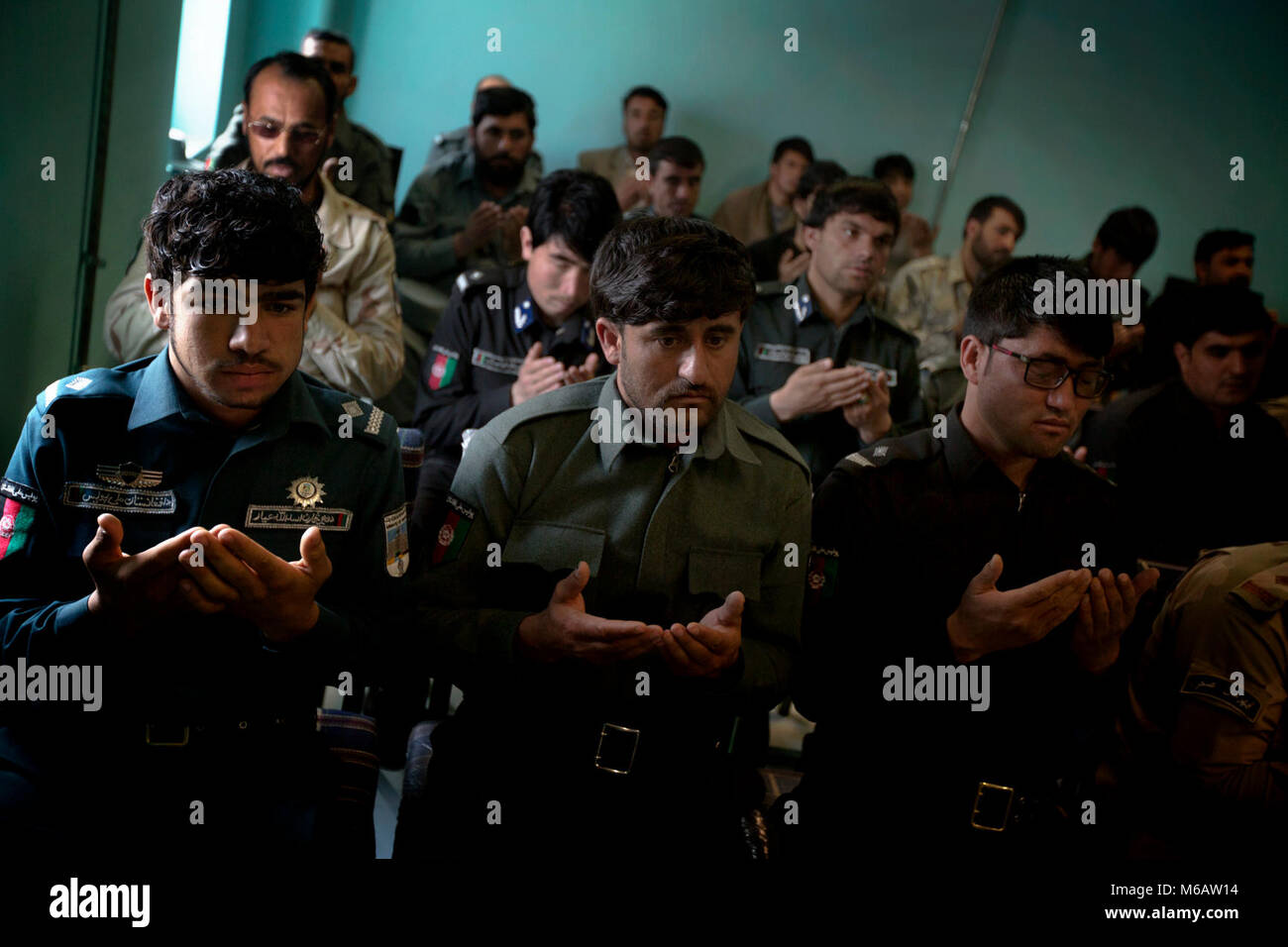 Policemen with the 505th Zone Afghan National Police (ANP) pray ...
