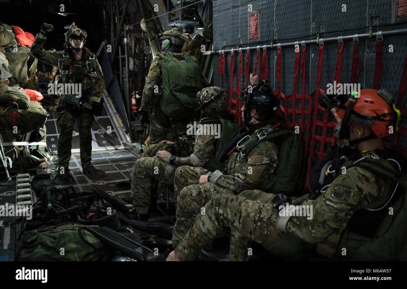 A U.S. Air Force 320th Special Tactics Squadron pararescueman signals ...