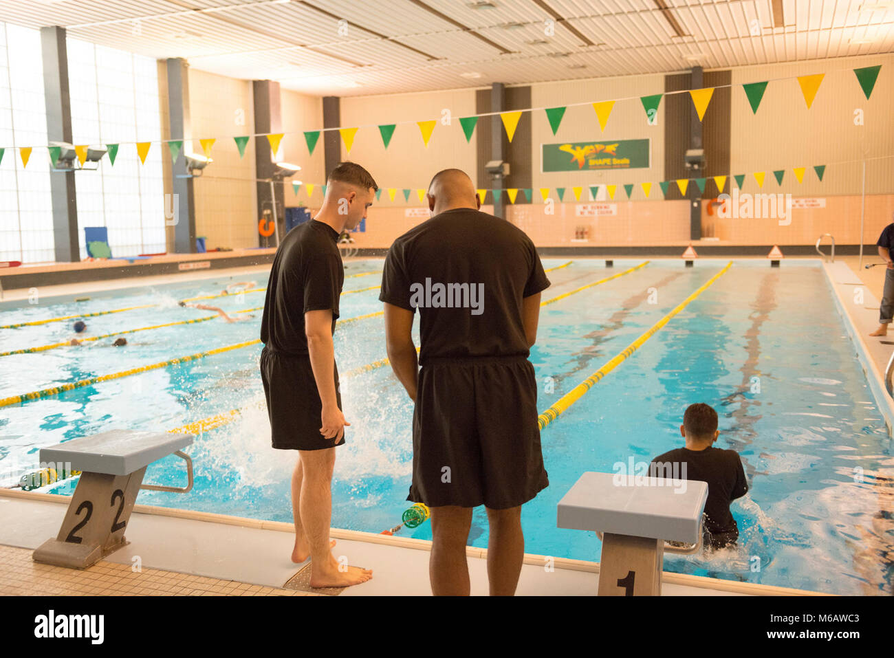 U.S. Soldiers watch as U.S. Army Garrison Benelux competitors jump in ...