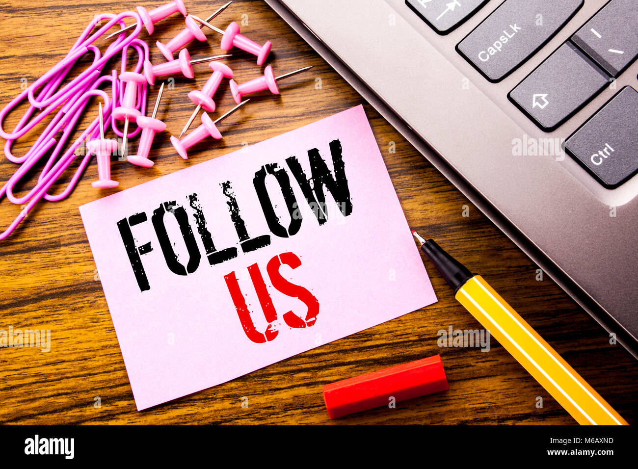 Handwritten text showing Follow Us. Business concept for Social Media ...