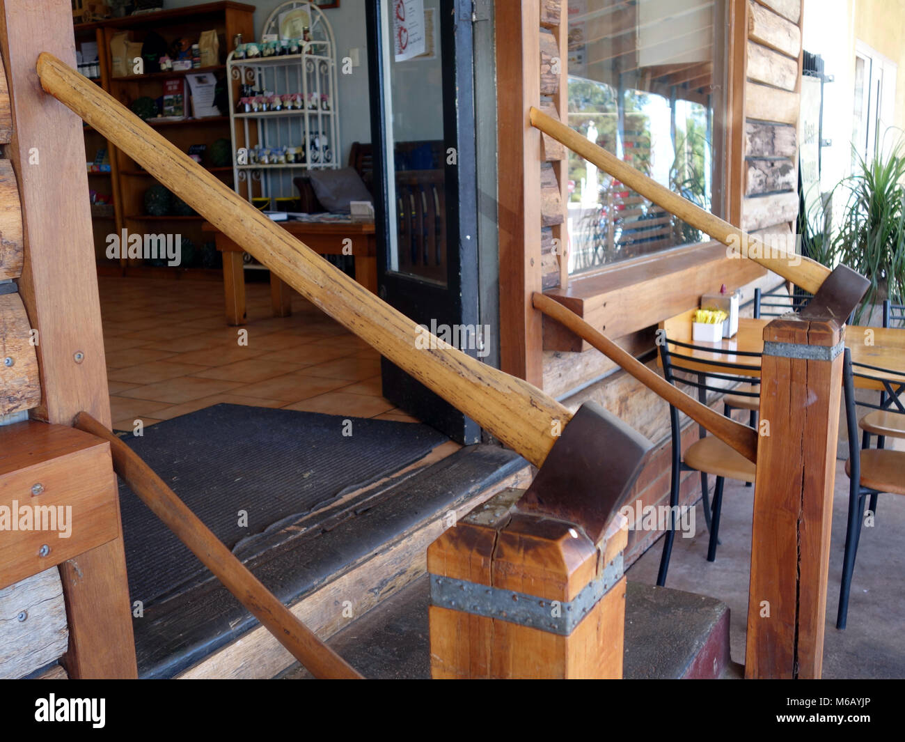 Two Axes hammered into wooden posts forming hand rails up steps into a ...