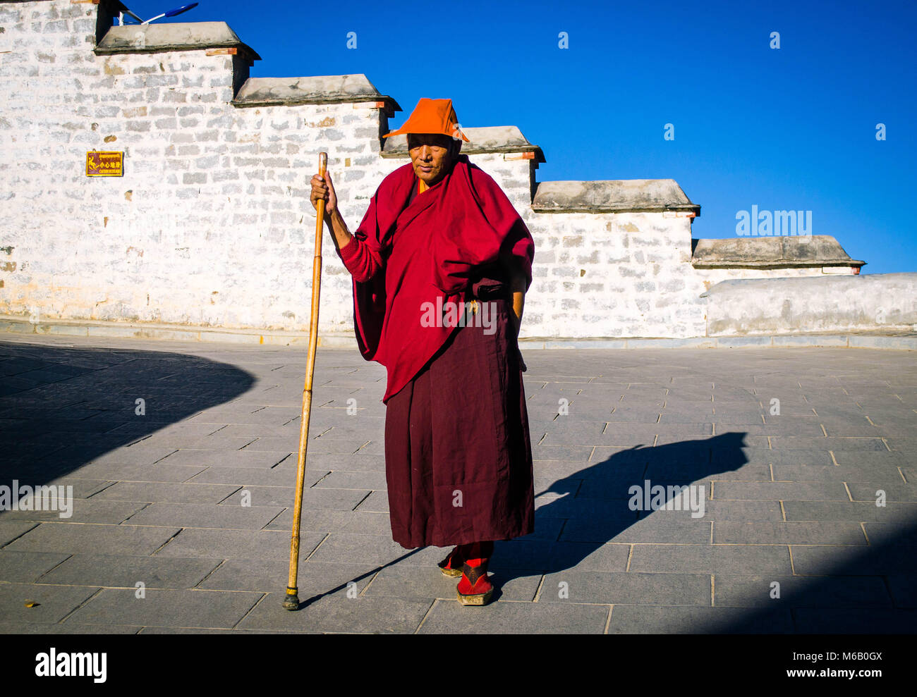A Tibetan Monk in red robe Stock Photo - Alamy