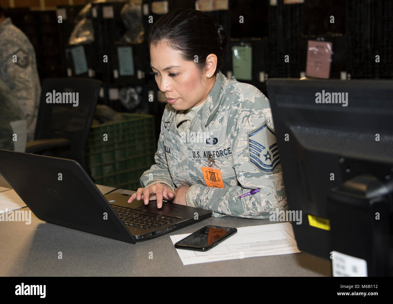 An Airman with the 60th Aerial Port Squadron, checks data on a laptop ...