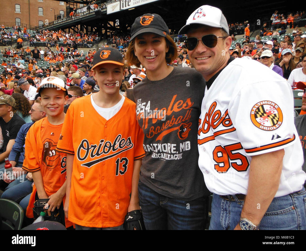 Military couple with family at baseball game Stock Photo - Alamy