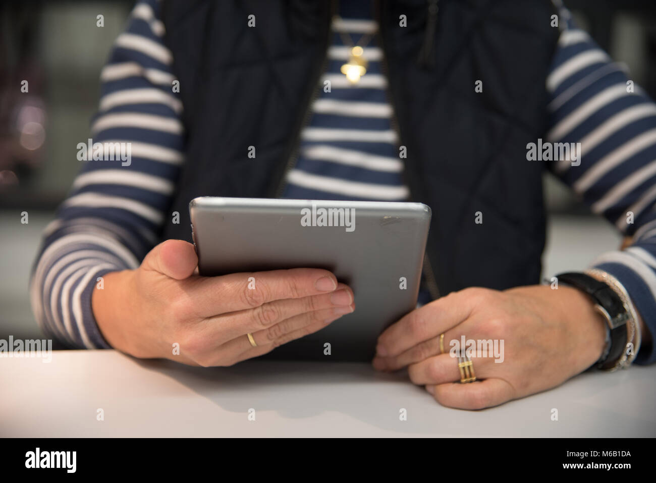 Close up of woman reading a tablet. Selective focus Stock Photo - Alamy