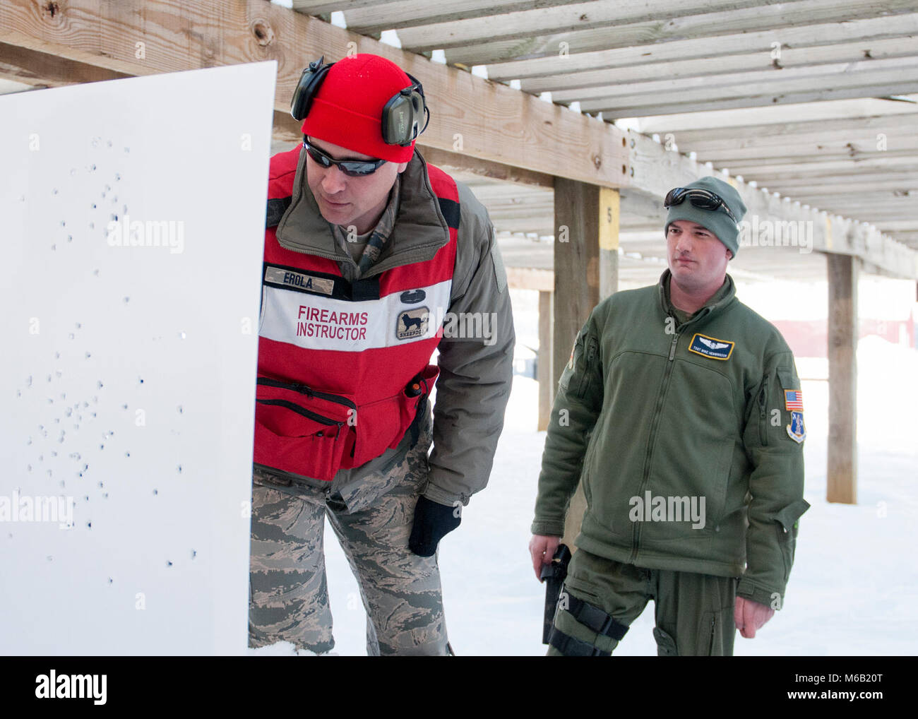U.S. Air Force Tech. Sgt. Brian Erola, left, a combat arms training and ...