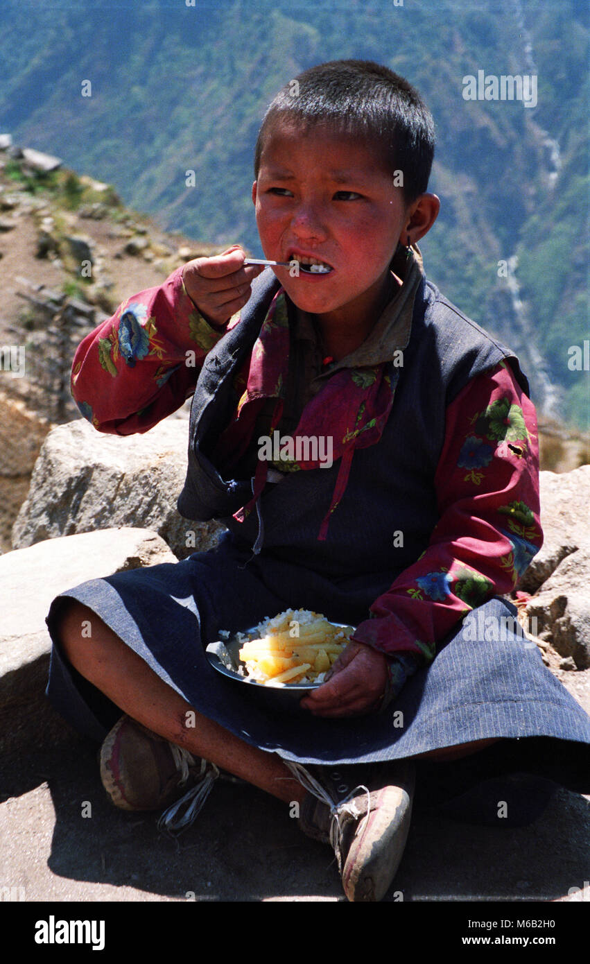 A young Nepali girl eating Dhal Bhat with veggies Stock Photo - Alamy