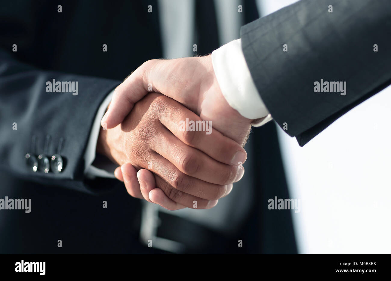 Business men giving a handshake. Business concept Stock Photo - Alamy