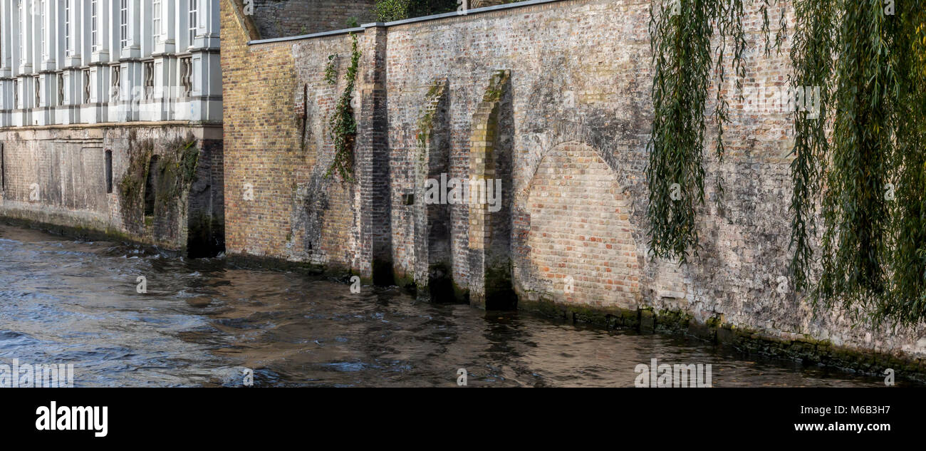Brick buttress supports on an ancient brick building on the canal in ...