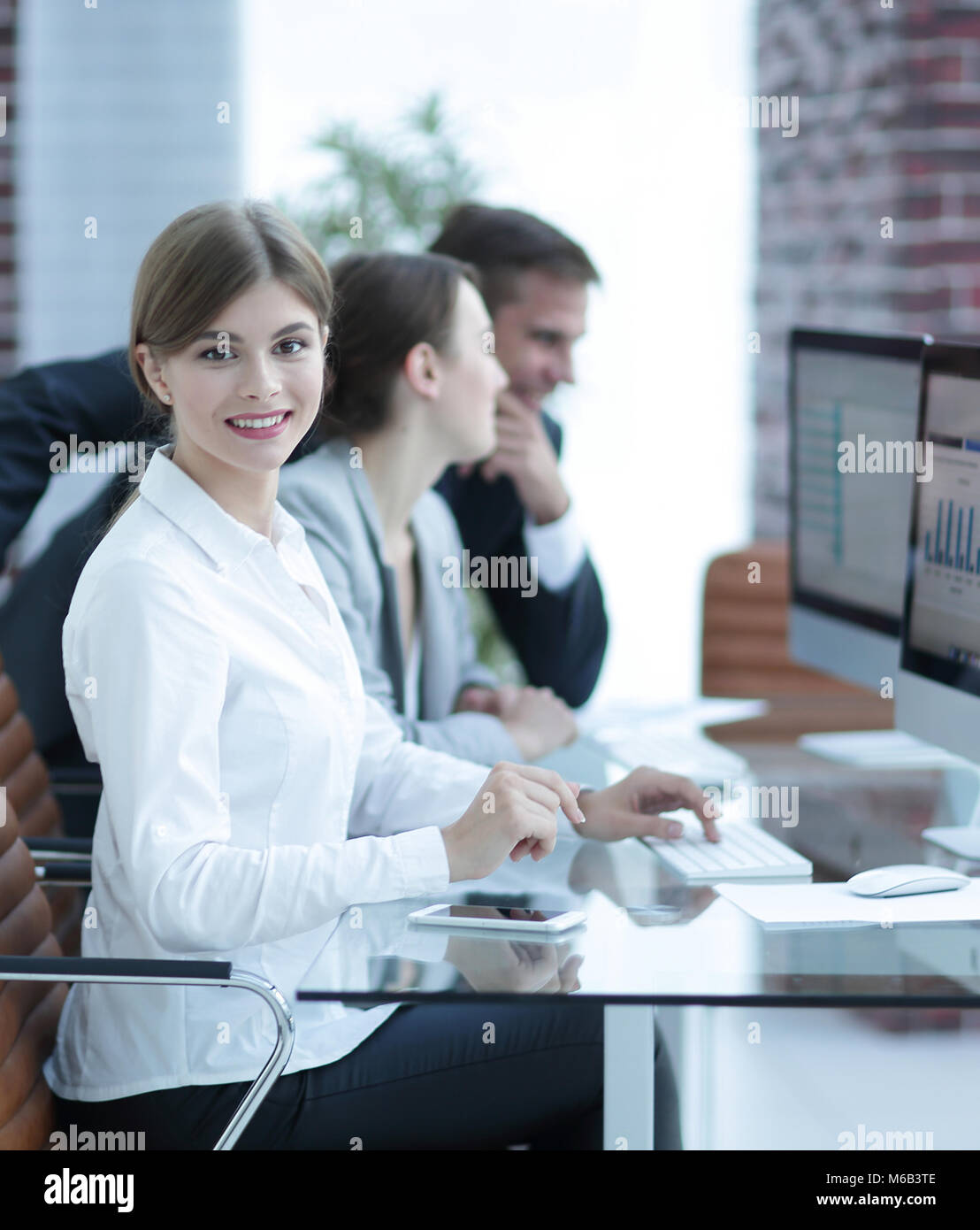 young employee sitting at a Desk Stock Photo - Alamy