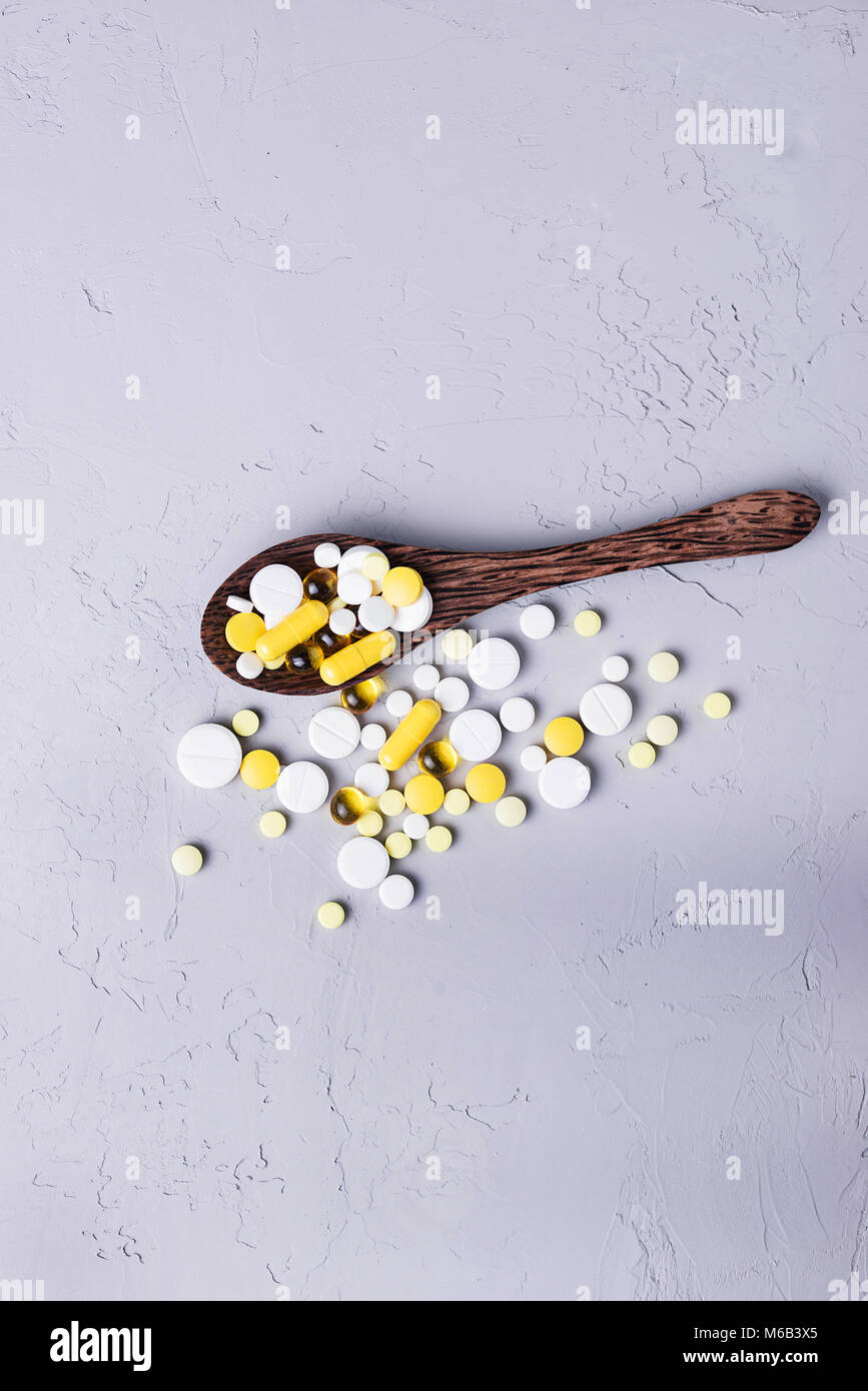 Different pills, tablets and capsules. on spoon. Top view Stock Photo ...