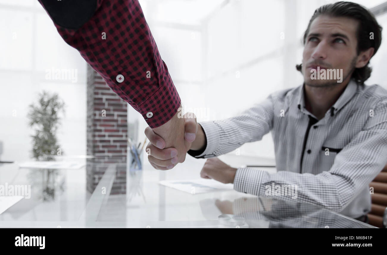 colleagues shaking hands over Desk Stock Photo - Alamy