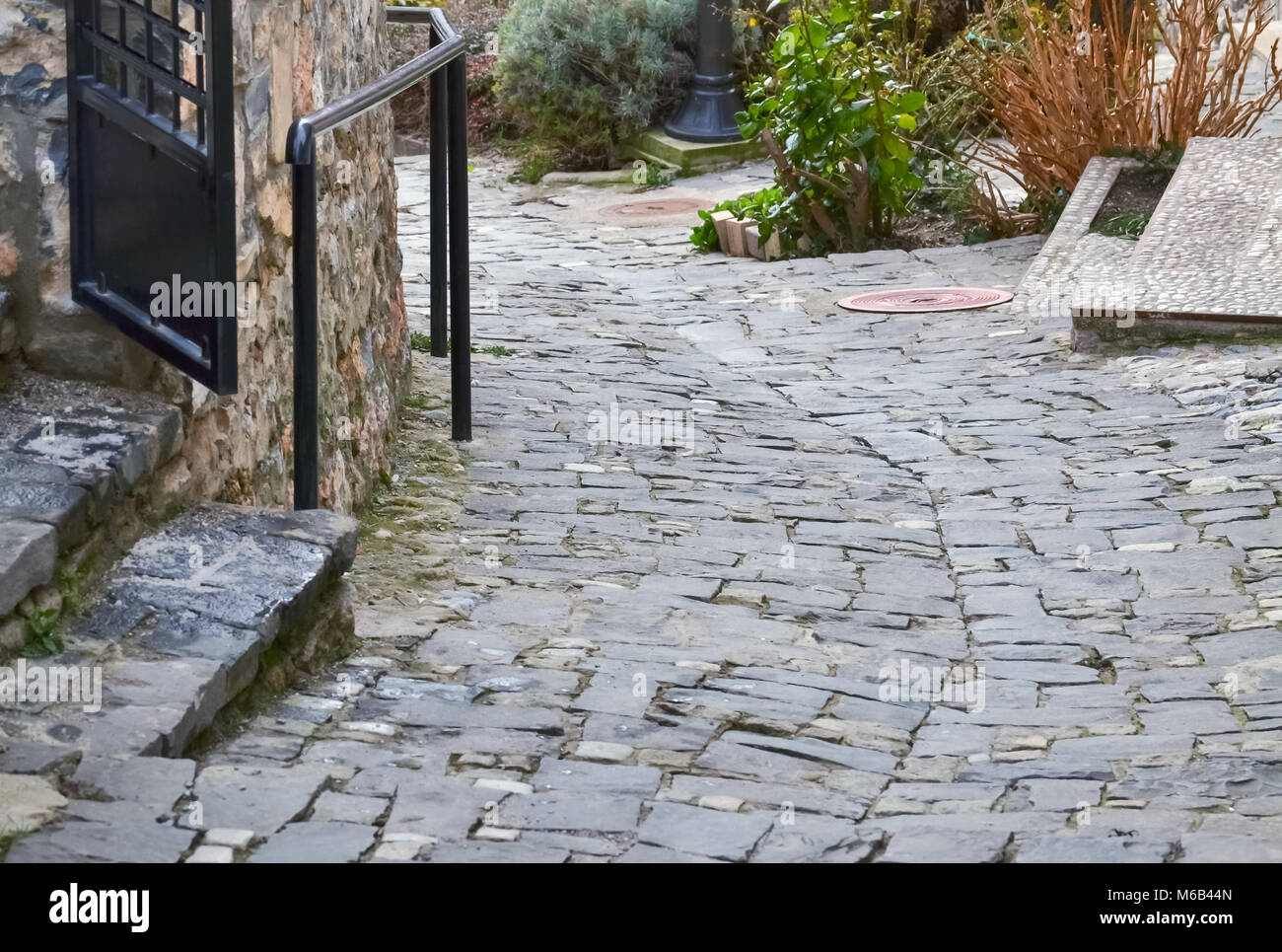 Detail of a small pedestrian street in Ohrid city made of cobblestone ...