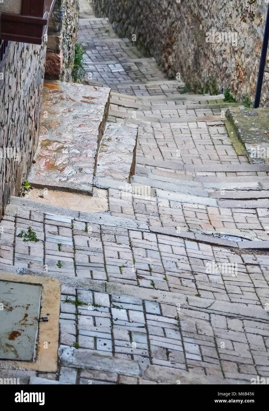 Detail of a small pedestrian street in Ohrid city made of cobblestone ...