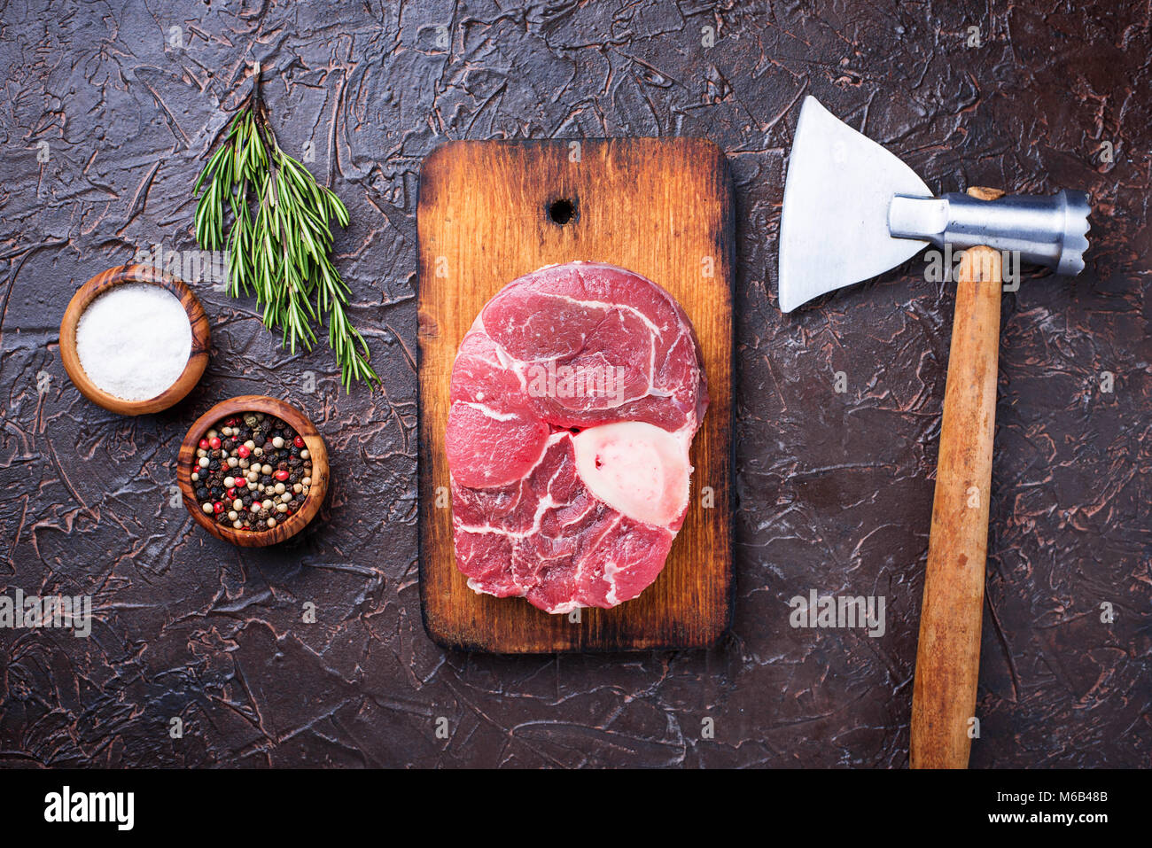 Raw meat osso buco and butchers axe. Top view Stock Photo - Alamy
