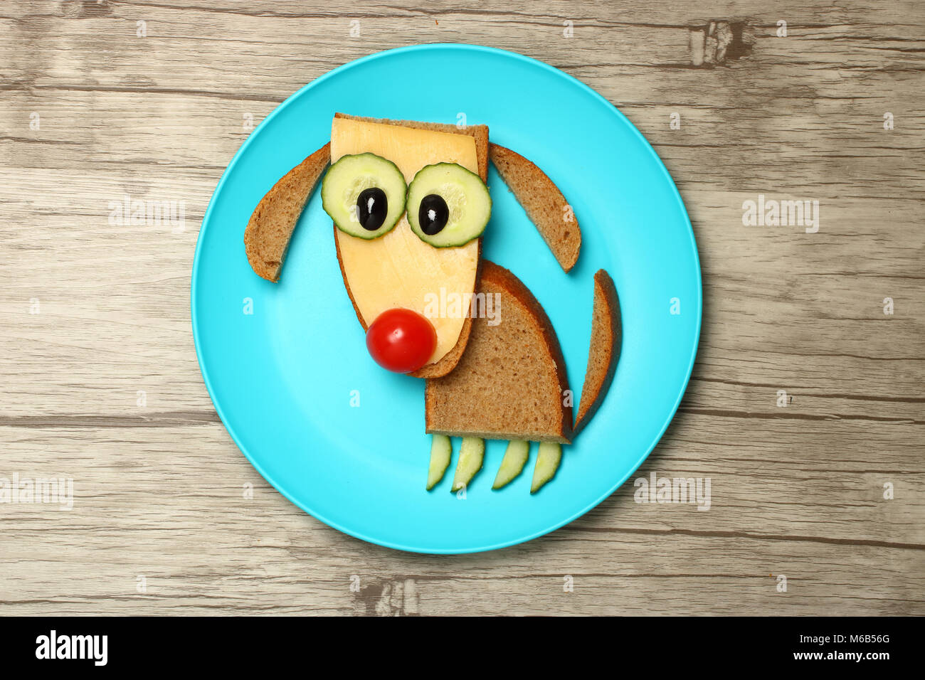 Funny sandwich dog made on plate and wood Stock Photo - Alamy