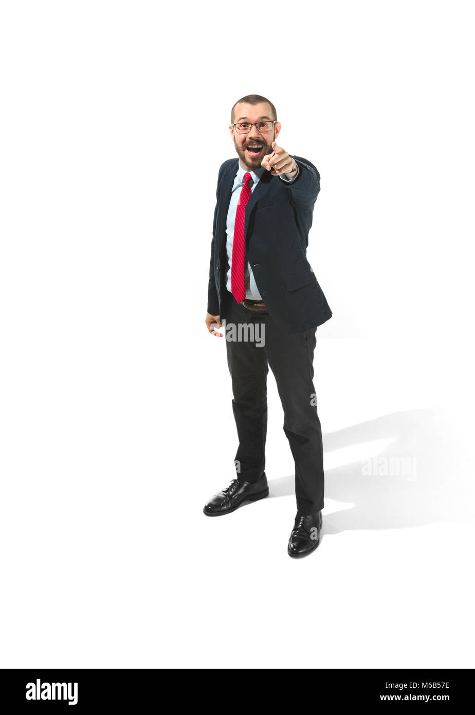 Full body portrait of happy businessman pointing to camera on white ...