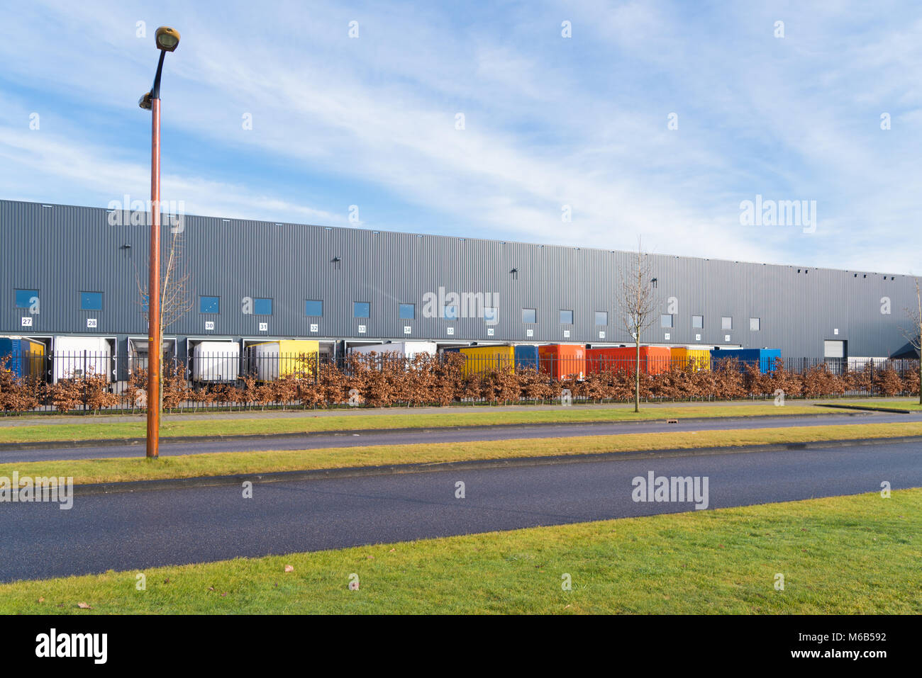 large commercial warehouse with trailers in front Stock Photo - Alamy