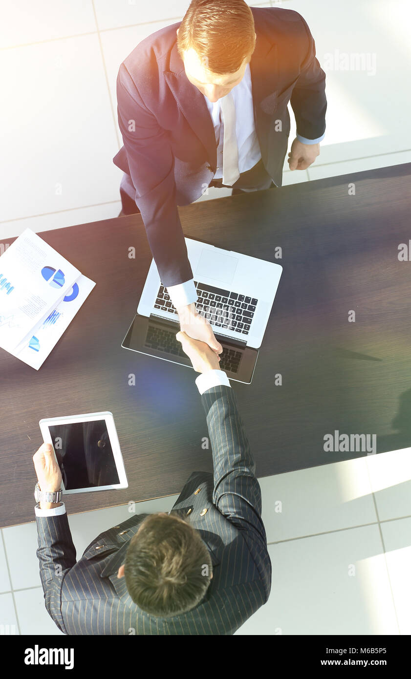handshake of business partners above the Desk Stock Photo - Alamy
