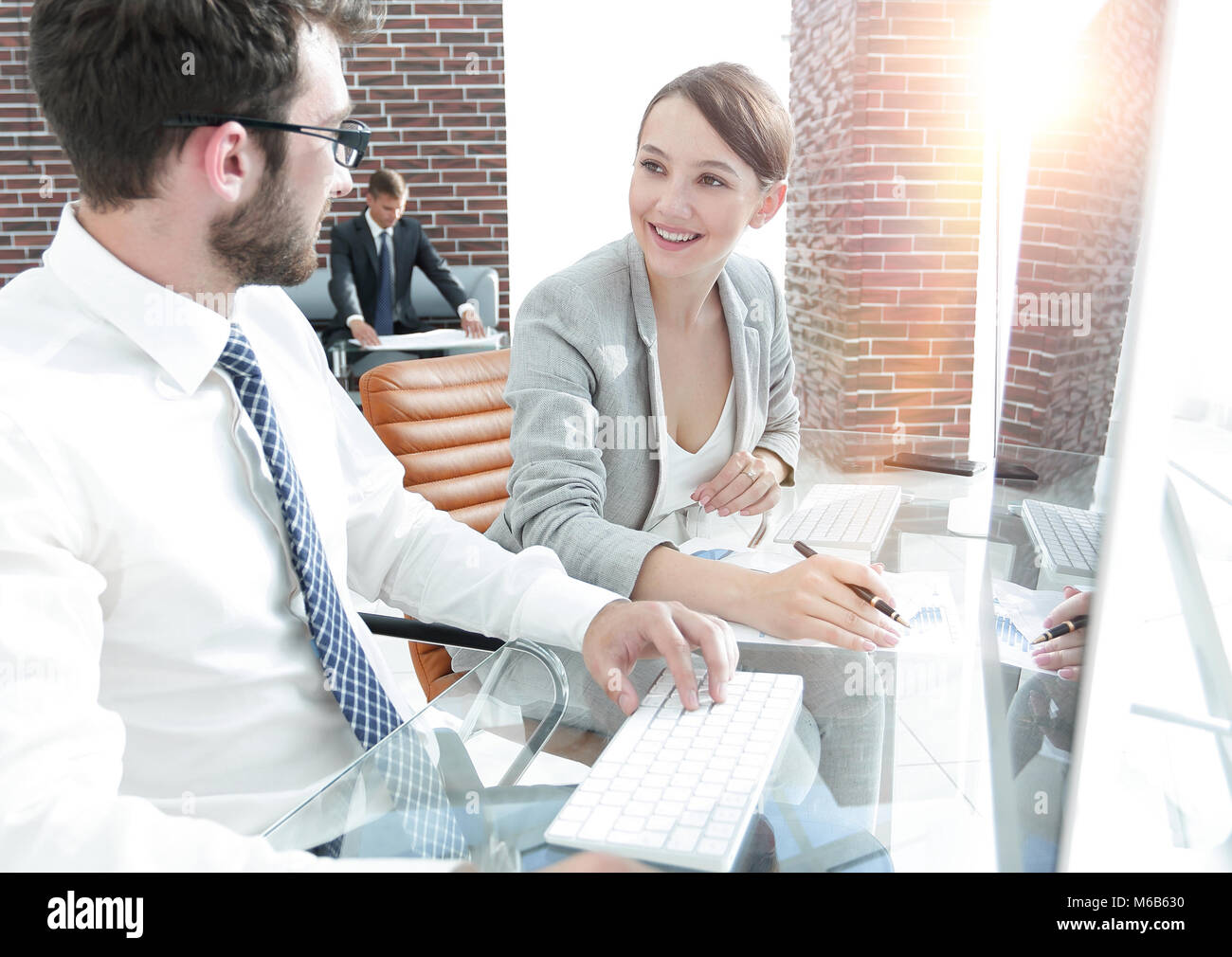young professionals sitting behind a Desk Stock Photo - Alamy