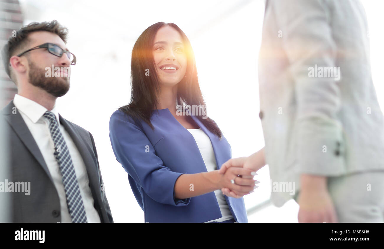 Businesswomen Shaking Hands In Modern Office Stock Photo - Alamy