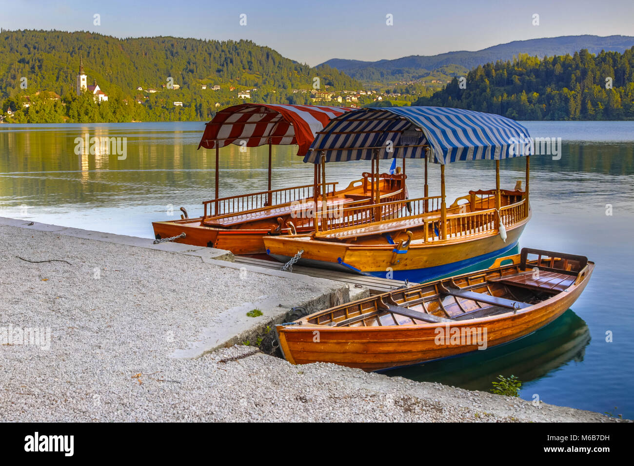 Traditional Pletna boats on beautiful lake Bled. In the background is ...