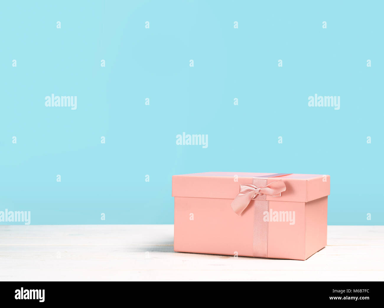 Pink gift box on blue background Stock Photo - Alamy