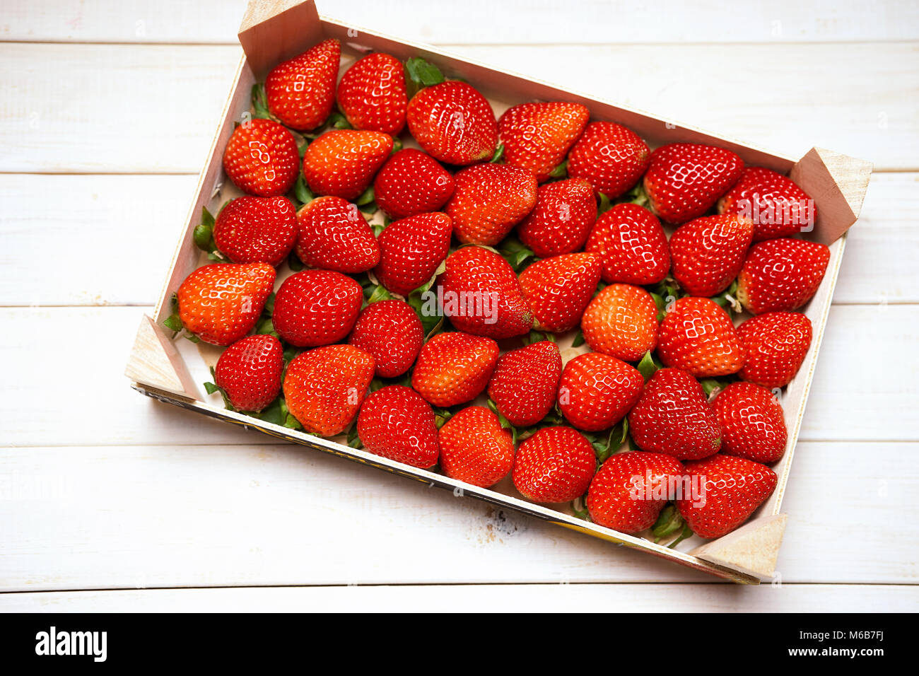 Strawberry in white wooden package Stock Photo - Alamy