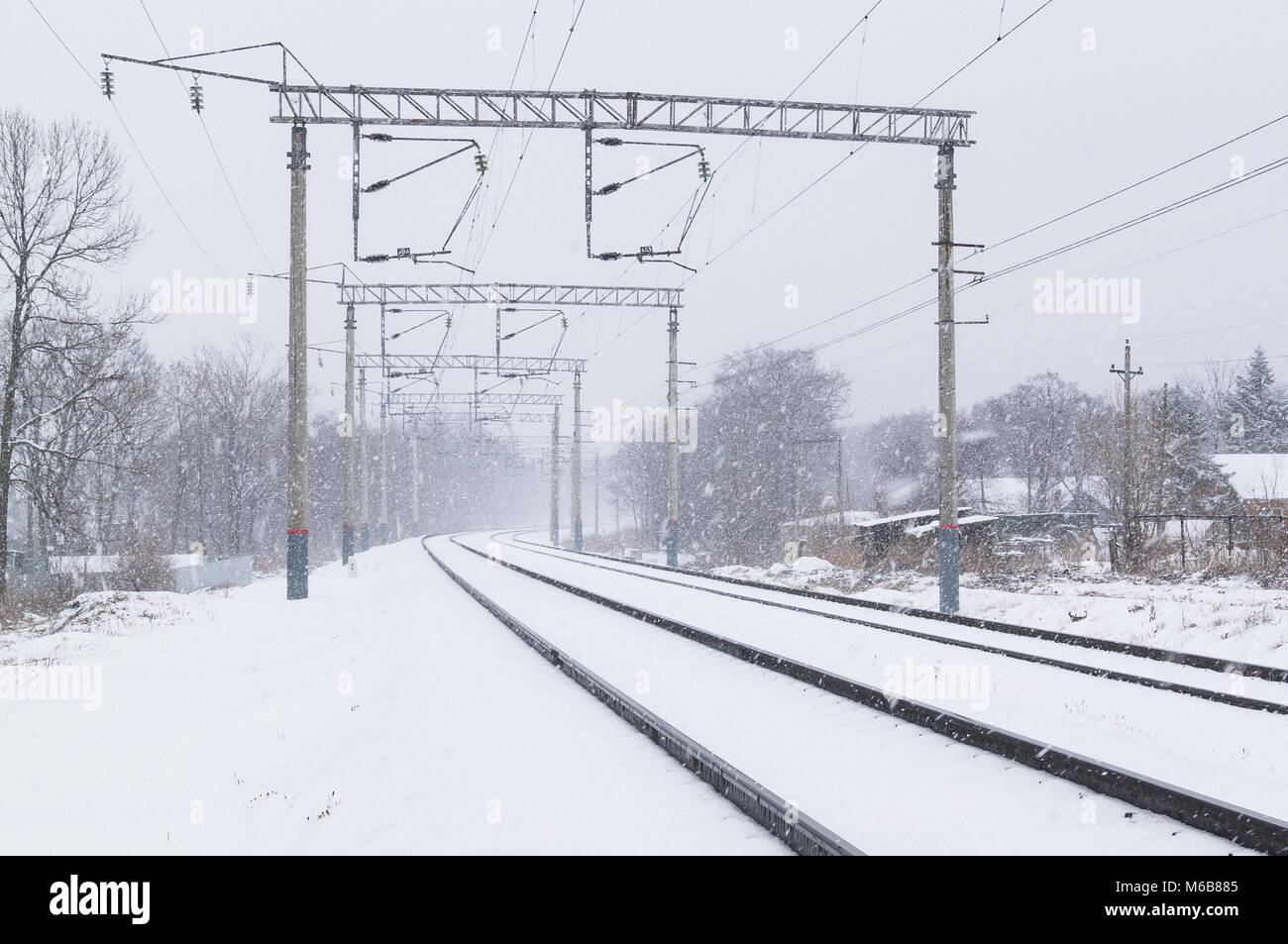 Winter and snowstorm on the railroad tracks. Strong wind and snowfall ...