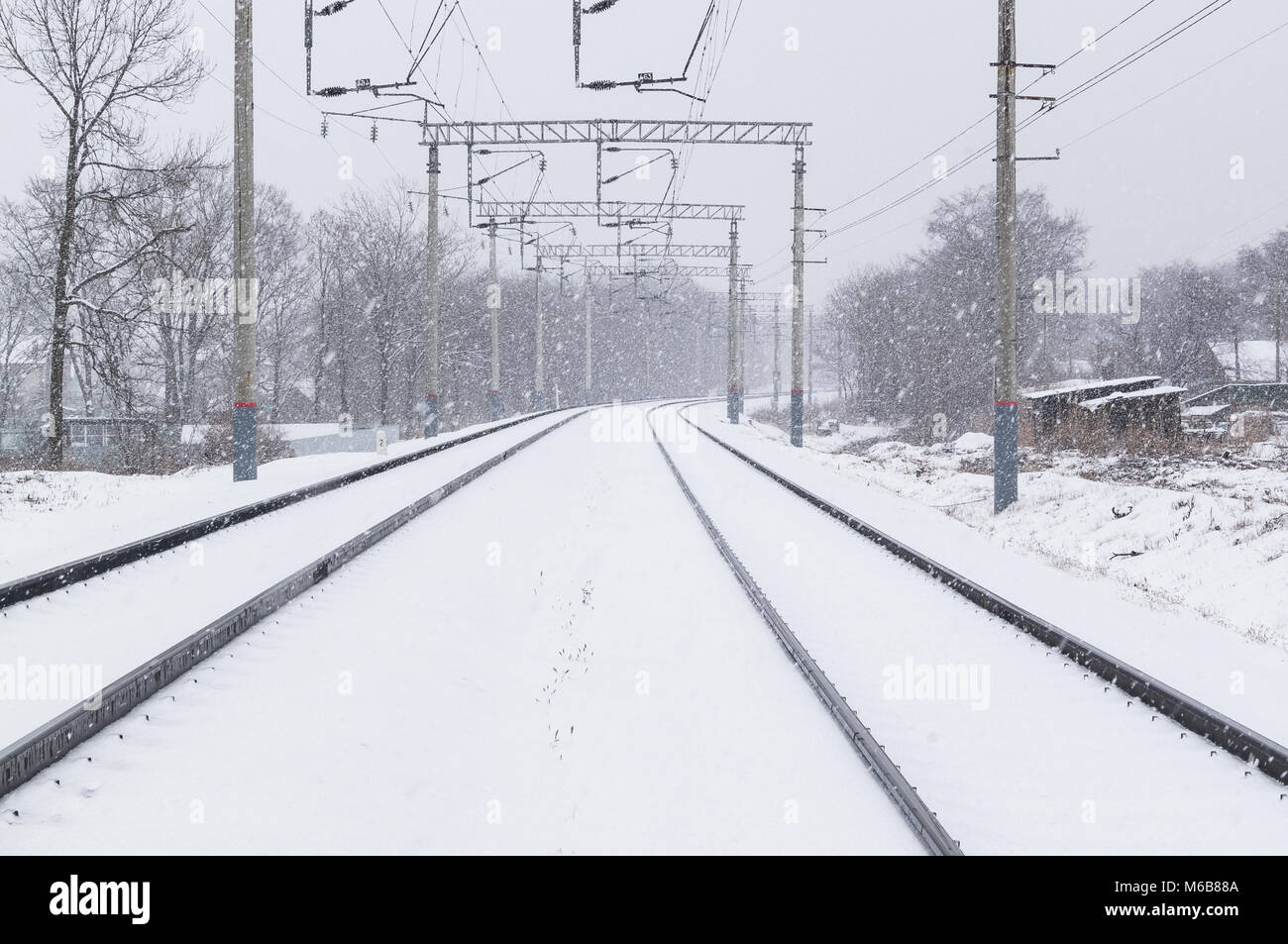 Winter and snowstorm on the railroad tracks. Strong wind and snowfall ...