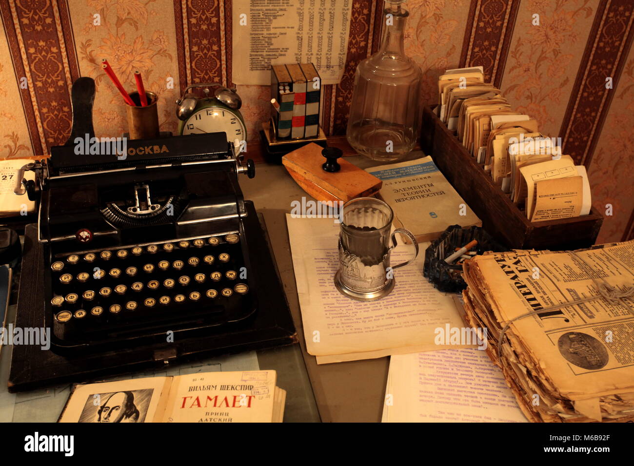 Old typewriter, an ashtray and newspaper files papers on the table ...